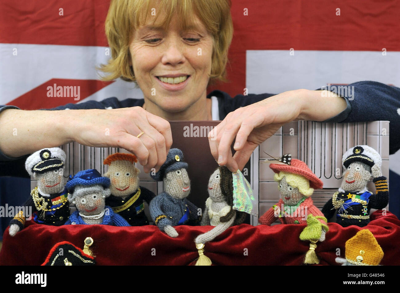 Fiona Goble adjusts knitted figures she created of attendees at the ...