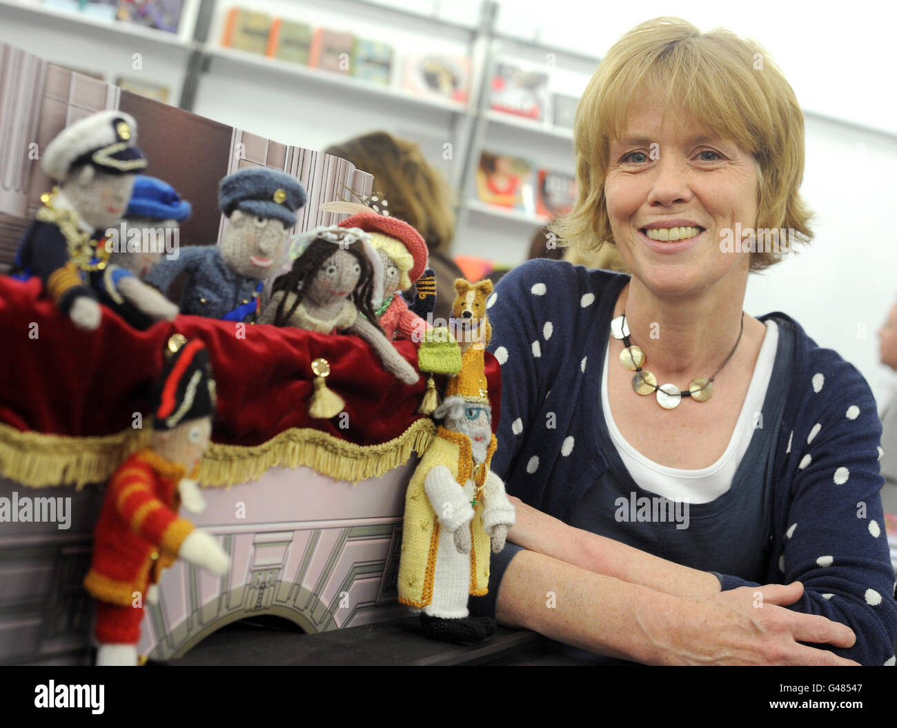 Fiona Goble poses with knitted figures she created of attendees at the ...