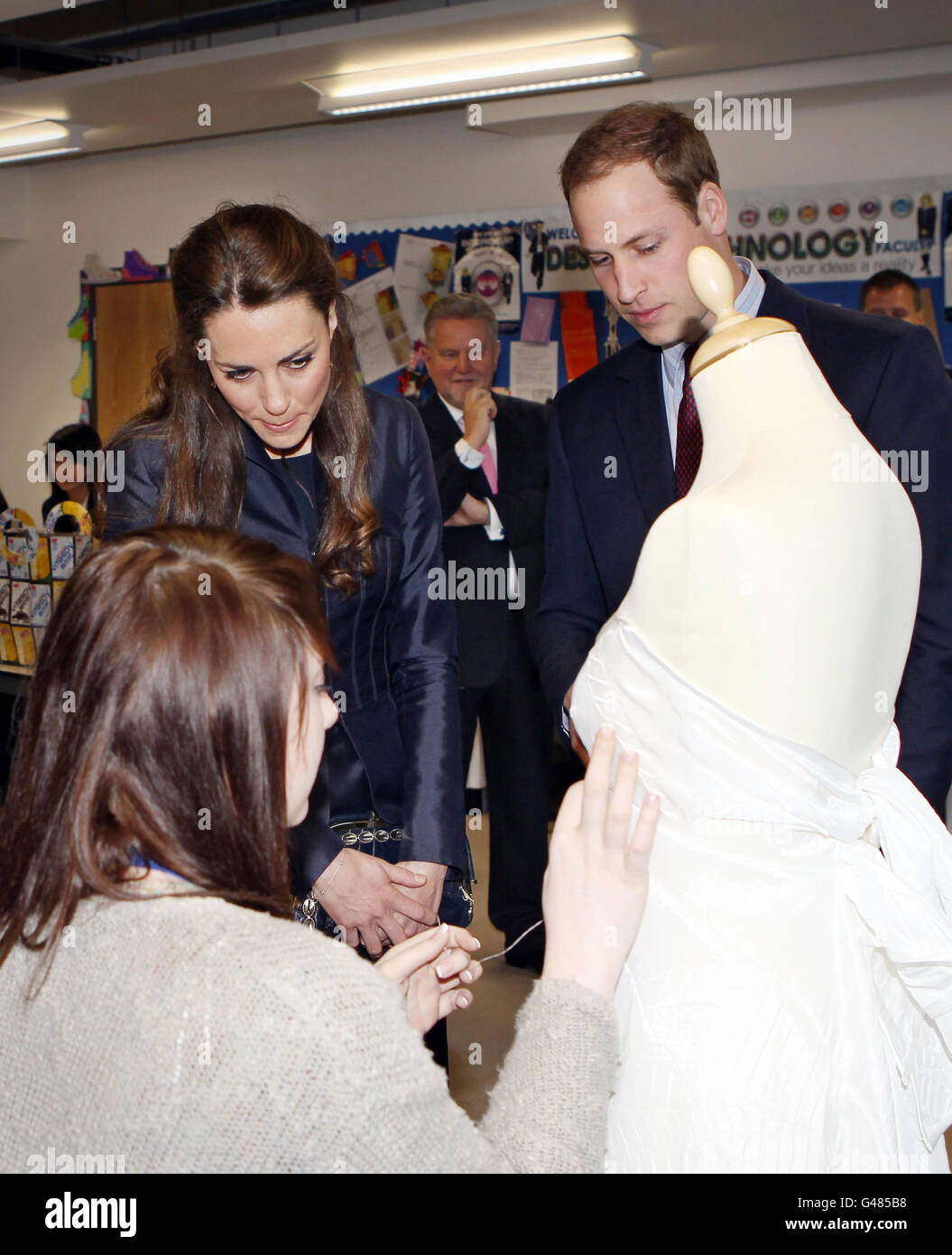 Prince William (right) and his fiancee Kate Middleton watch a student ...