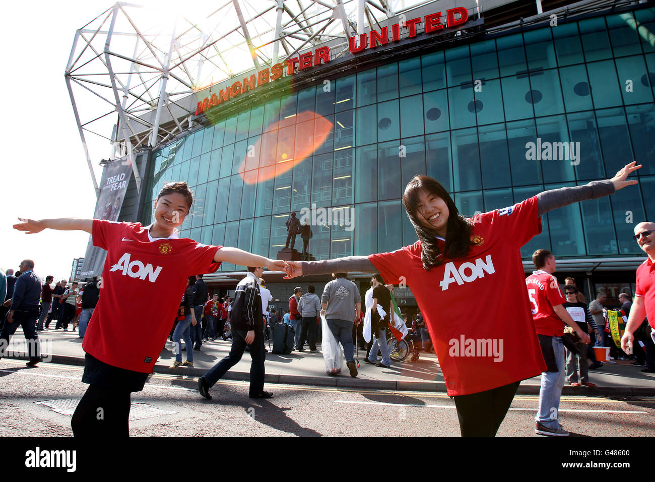 Two Manchester United fans pose for a photograph outside of Old ...