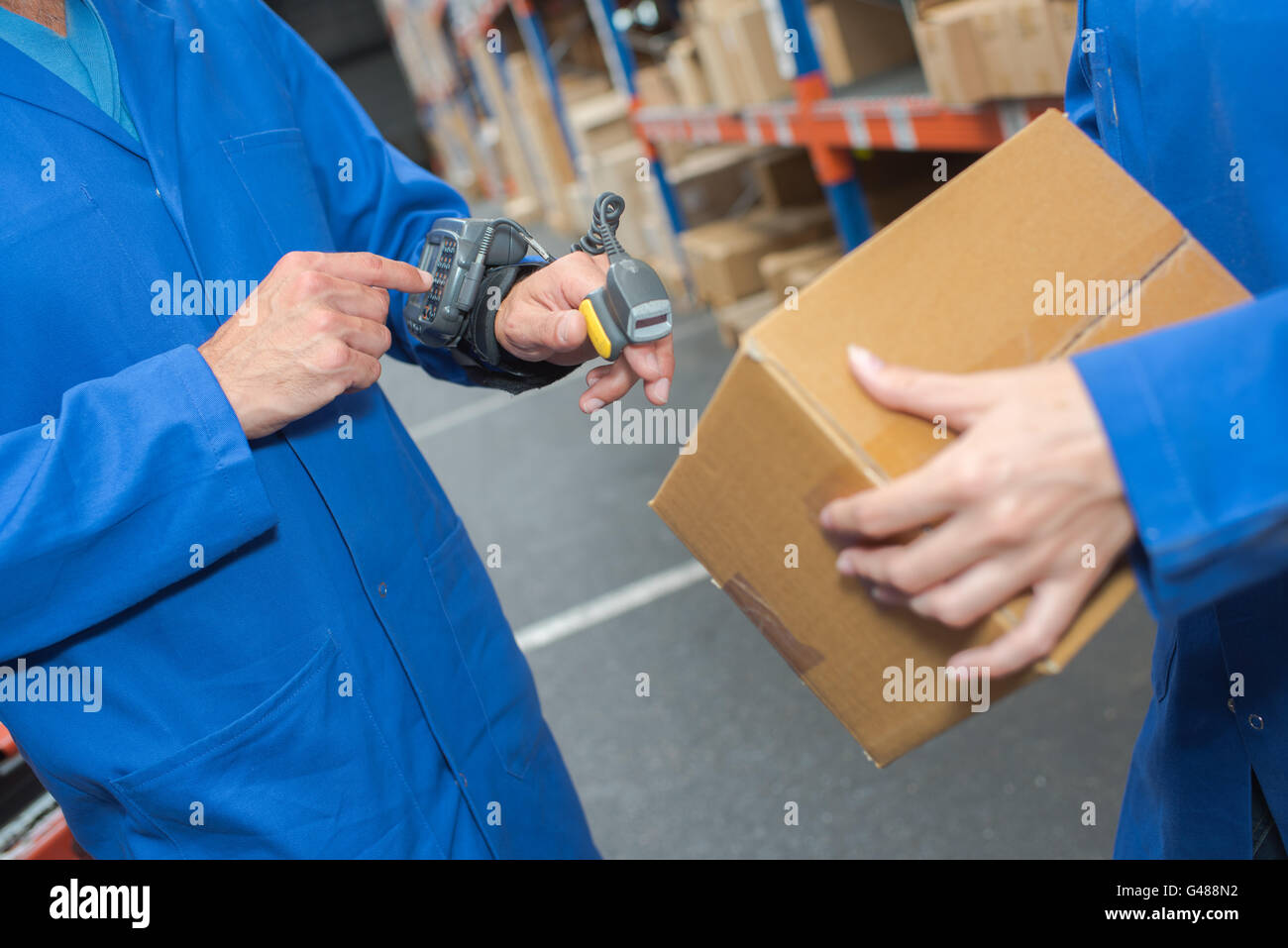Warehouse worker scanning packages using hi-res stock photography and ...