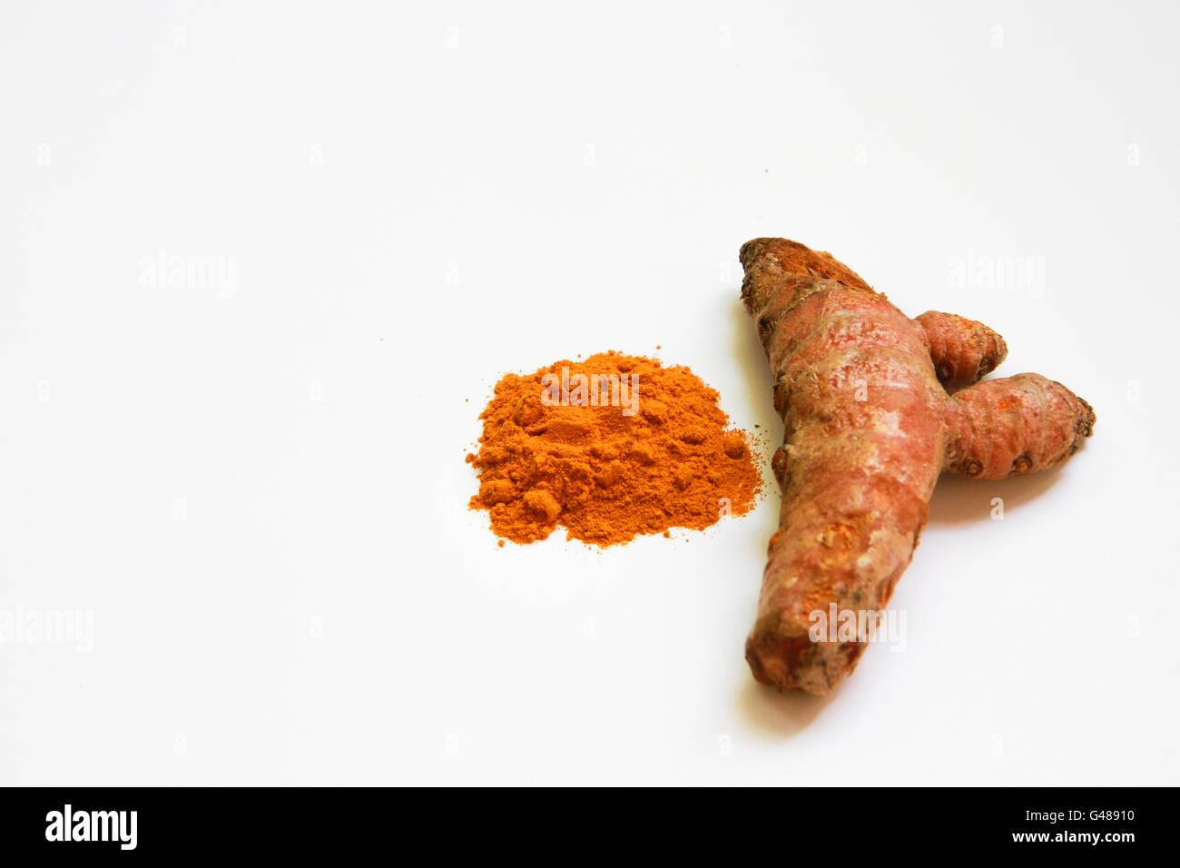 photo of turmeric root and turmeric powder isolated on white Stock ...