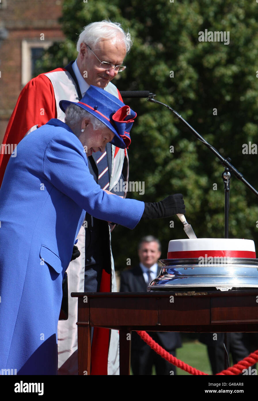 Britain's Queen Elizabeth II cuts a commemorative cake marking the ...