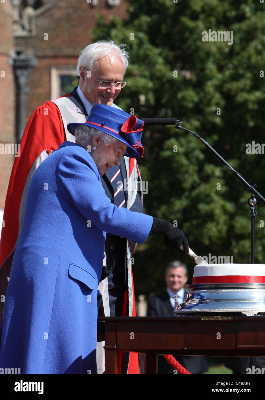 Britain's Queen Elizabeth II cuts a commemorative cake marking the ...