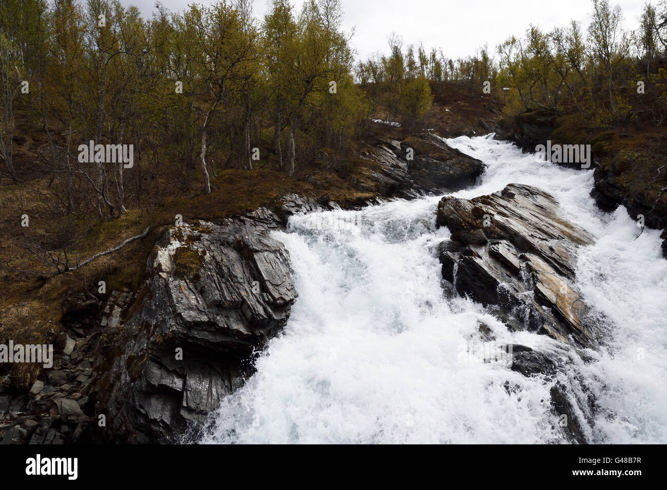 Water flowing in spring time in a river on the Sweden Norway border in ...