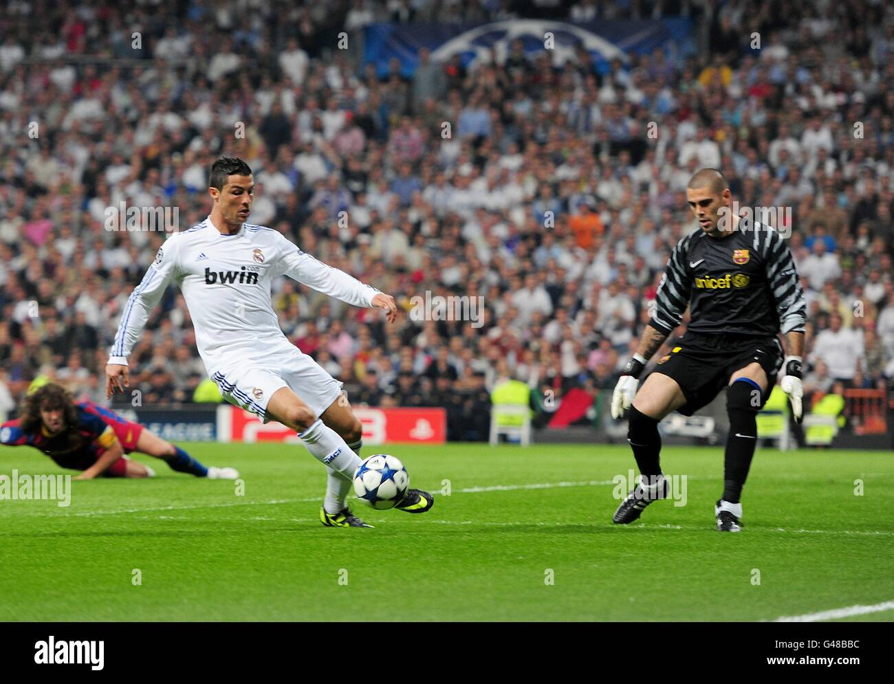 Real Madrid's Cristiano Ronaldo (left) takes on Barcelona goalkeeper ...