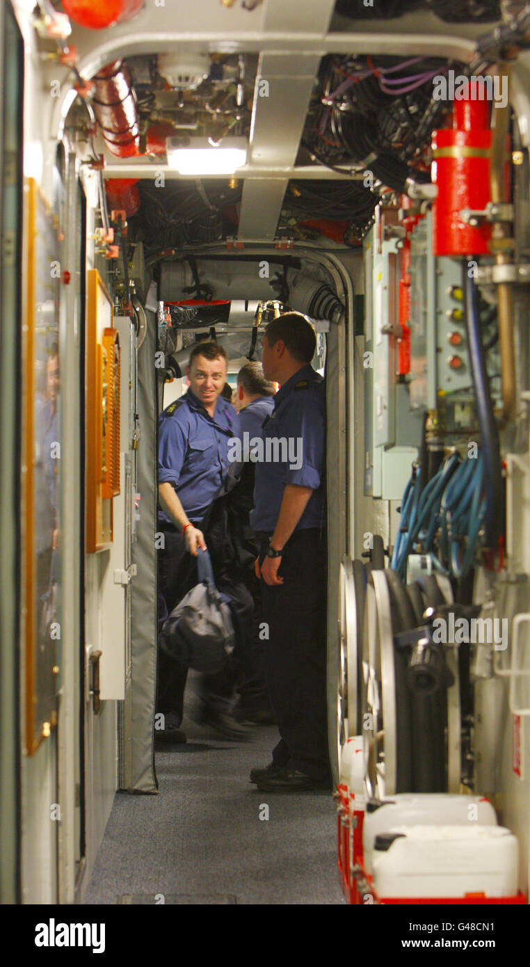 Crew members pass in a narrow corridor aboard the Royal Navy's newest ...