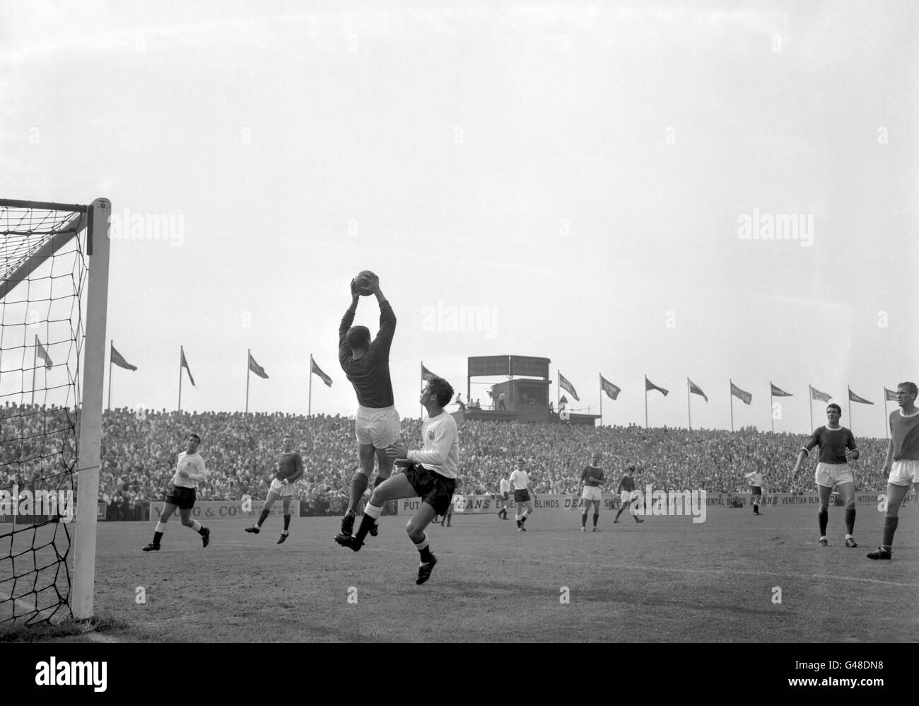 Manchester United goalkeeper David Gaskell retrieves the ball under ...