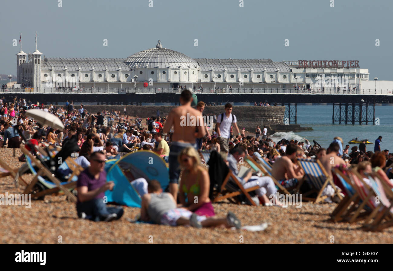 Sunbathers enjoy the sunshine in Brighton, East Sussex, as the warm ...