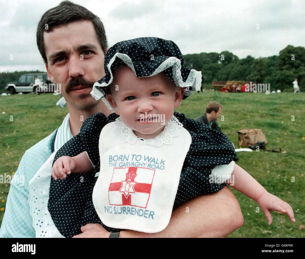 An Orange Order Supporter with his child at Edenderry field for the ...