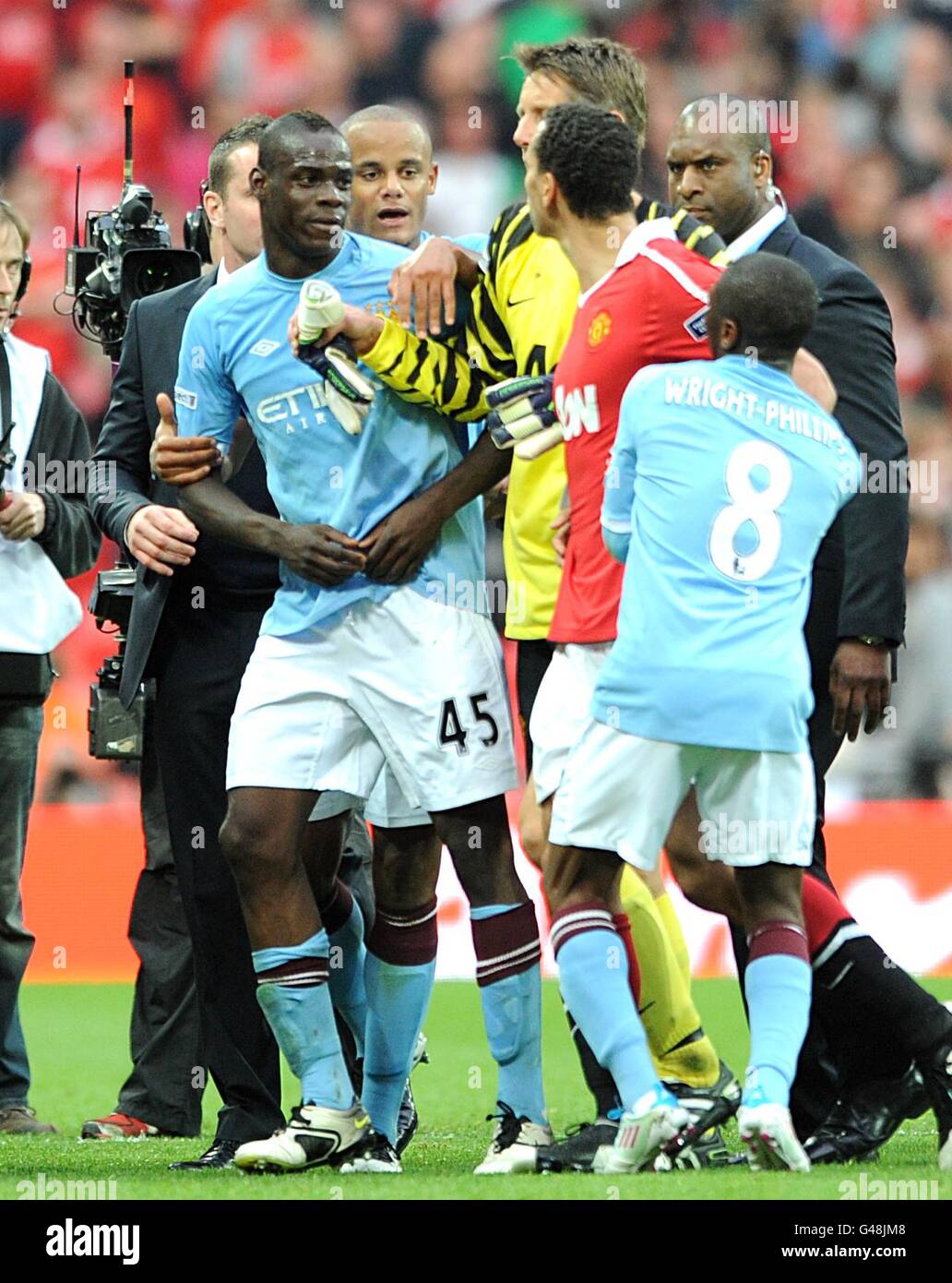 Manchester United's Rio Ferdinand (second right) and Manchester City's ...