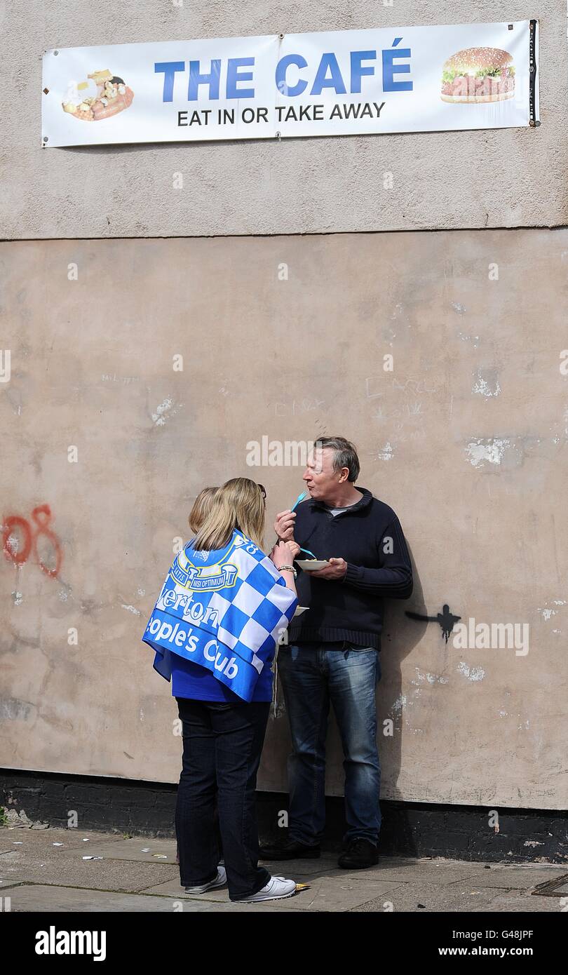 Everton fans eat food outside of Goodison Park before the match Stock ...