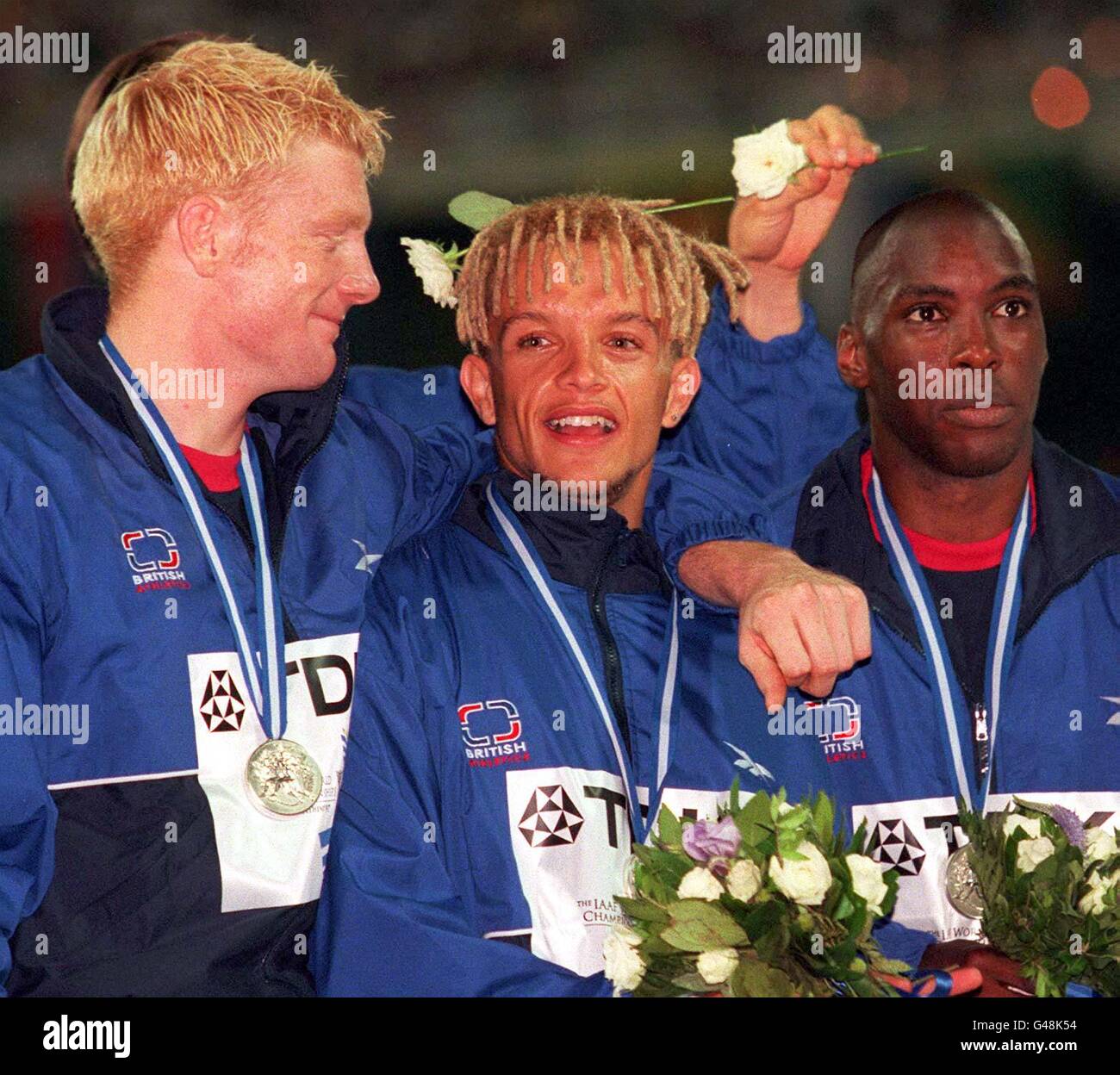 Flowers for Jamie Baulch (centre) from Iwan Thomas with Mark Richardson ...