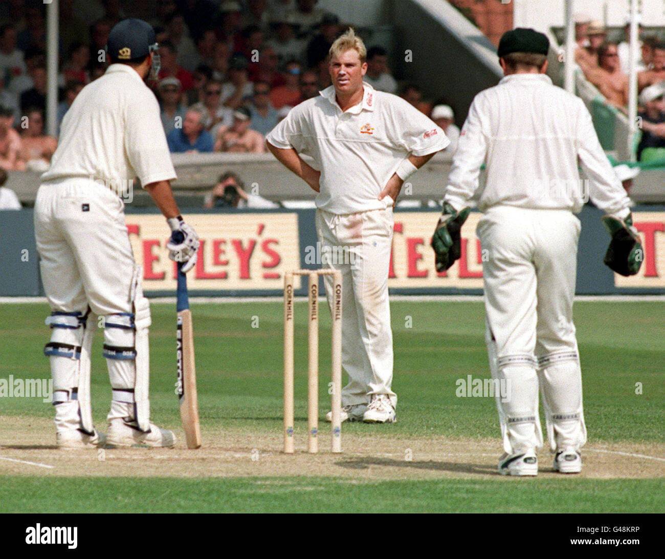 Australian bowler Shane Warne (centre) stares at Adam Hollioake after ...