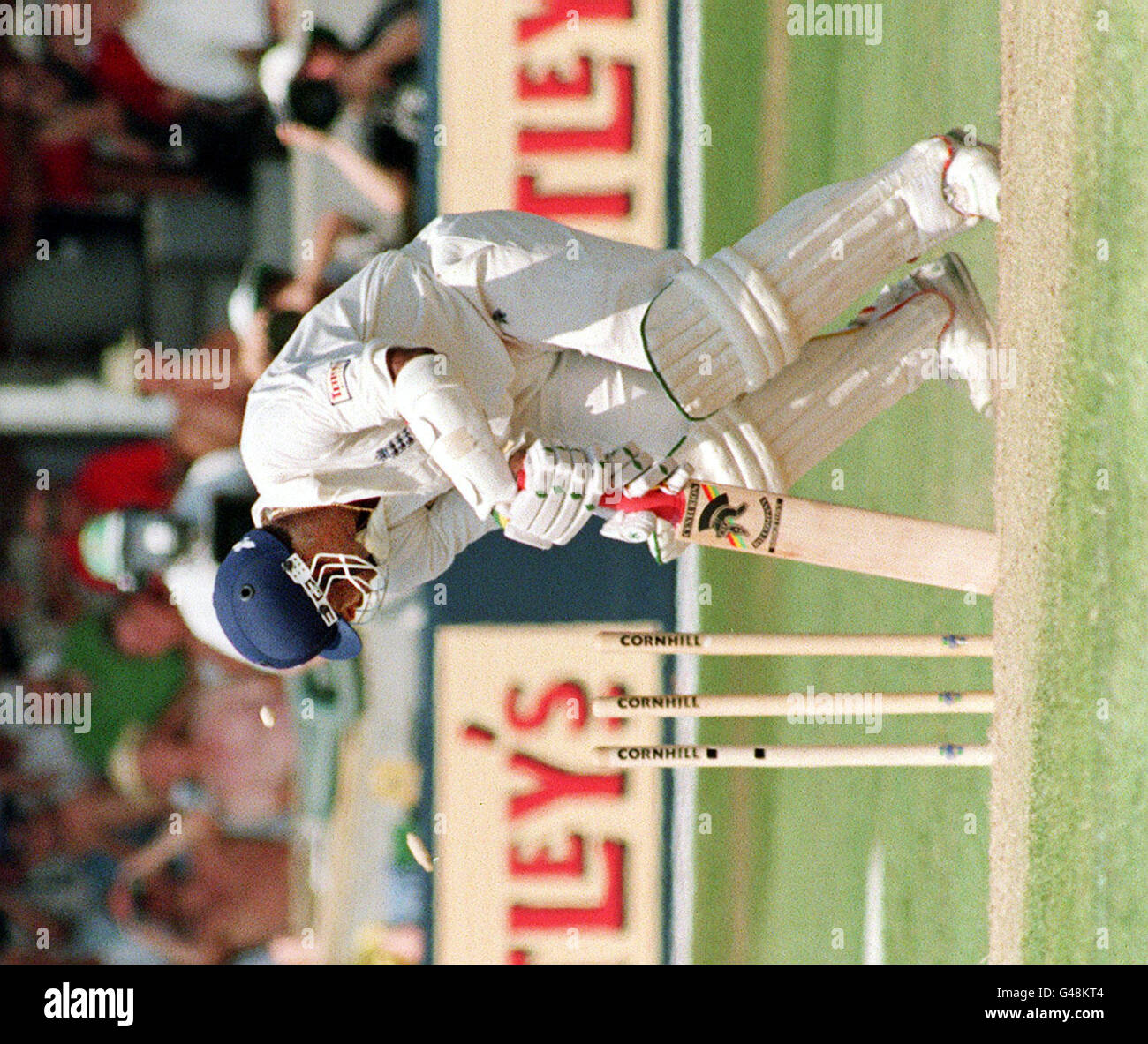 England's Devon Malcolm is bowled by Australia's Glenn McGrath, during ...