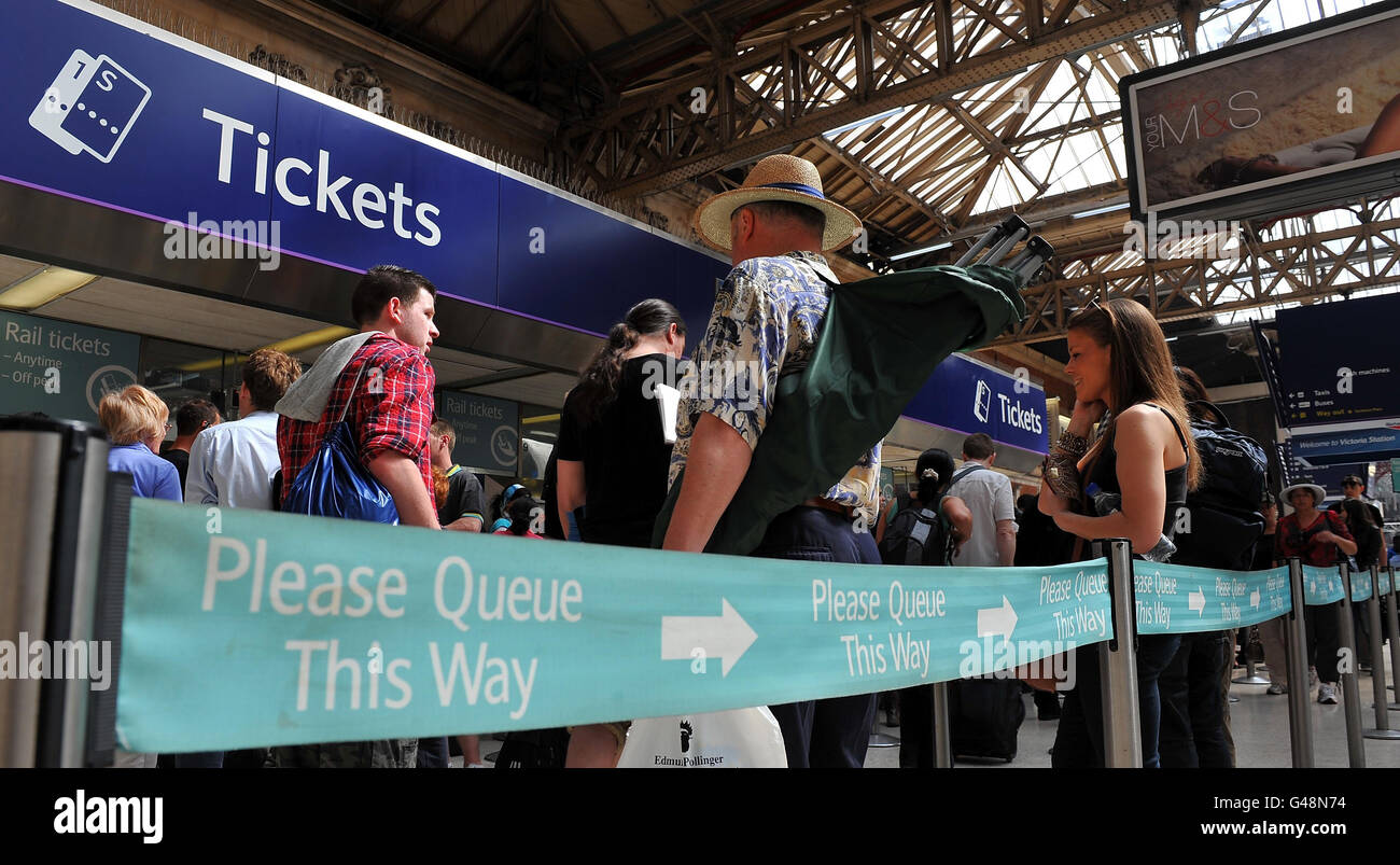 Passengers queue for tickets at Victoria Station in London, during the ...
