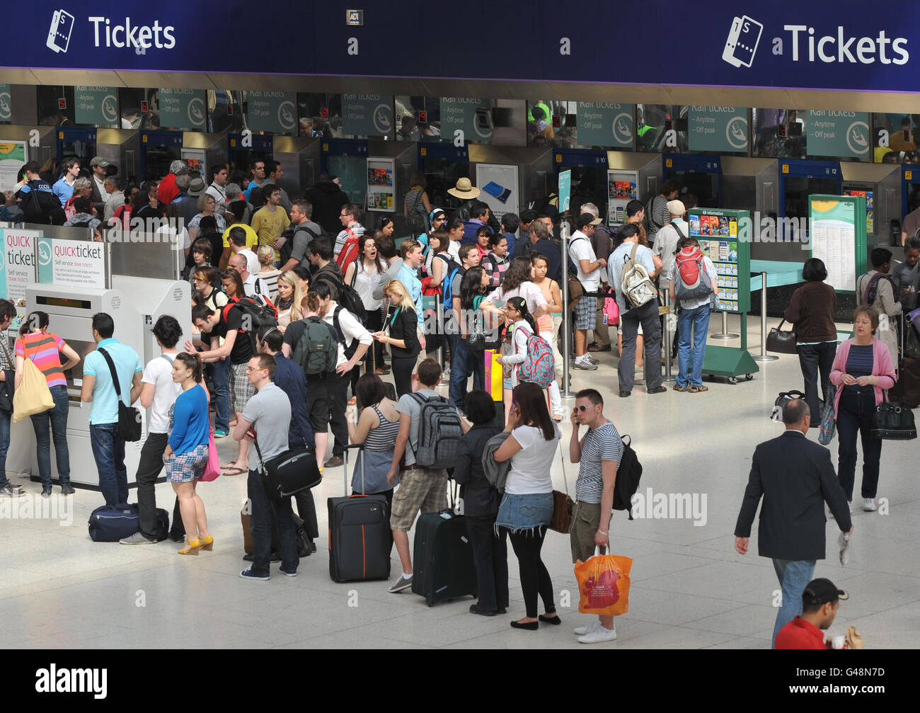 Passengers queue for tickets at Victoria Station in London, during the ...