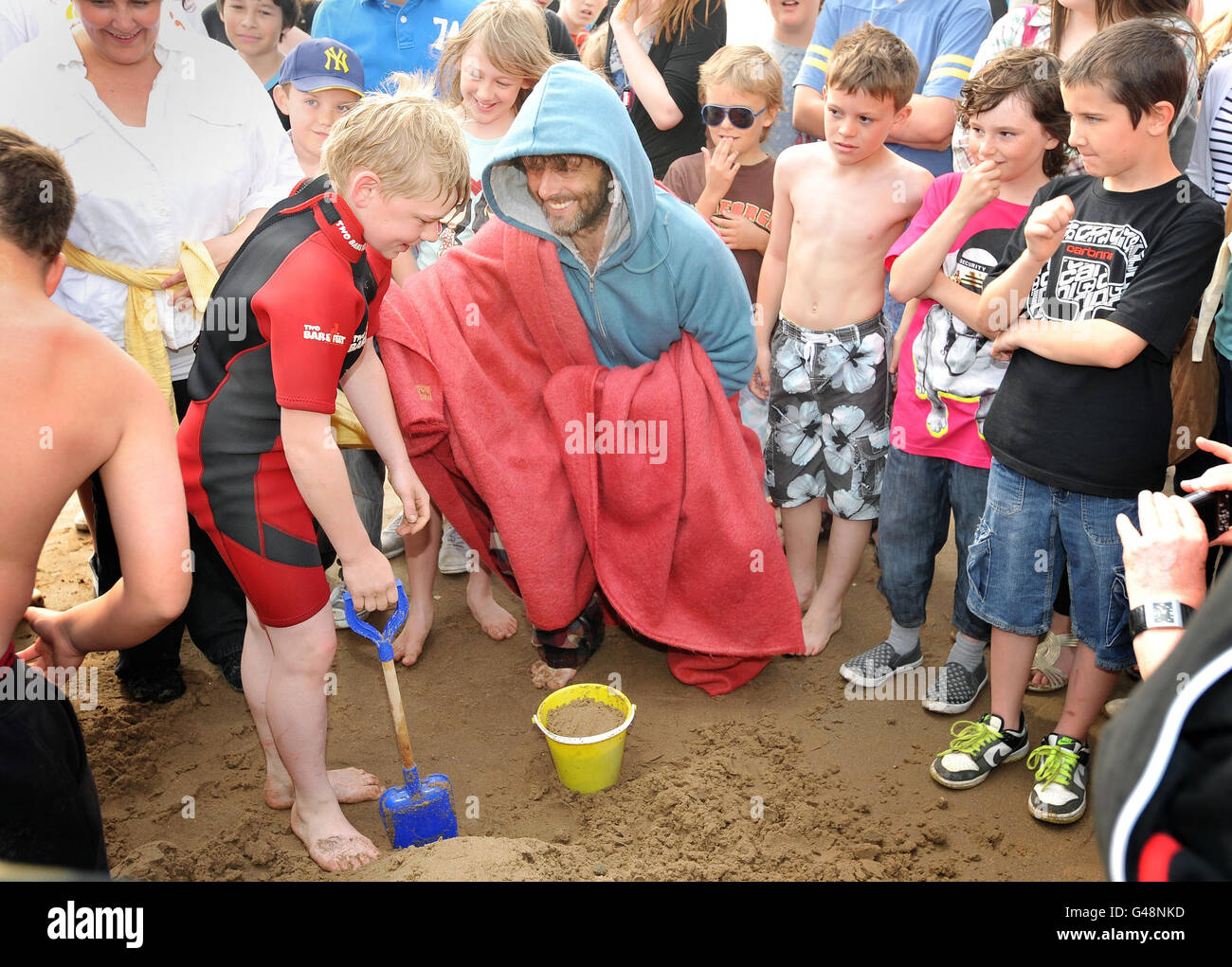 Michael Sheen on Port Talbot beach helps a boy with his sand castle ...