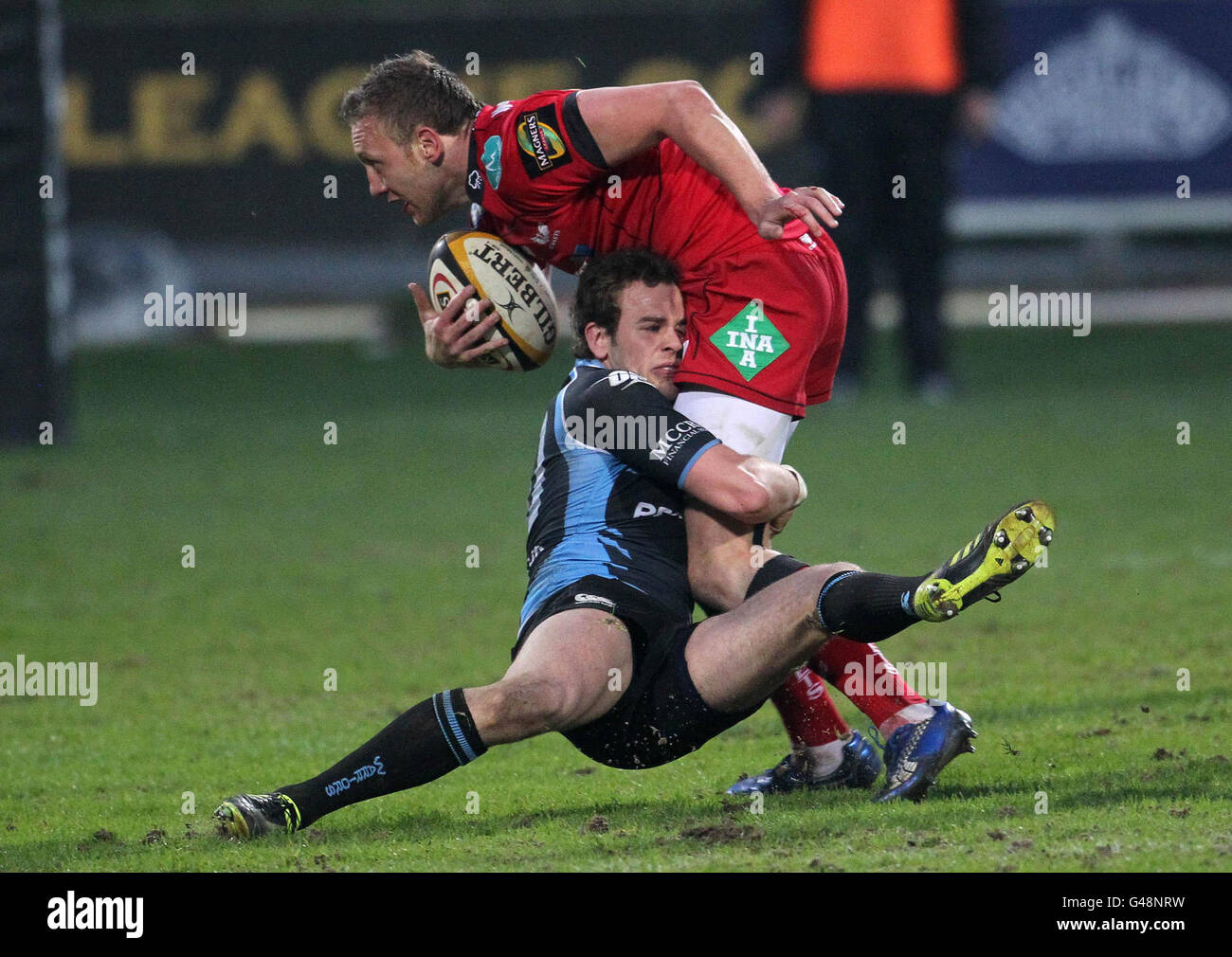 Glasgow's Ruaridh Jackson tackles Scarlet's Moran Stoddard (top) during ...