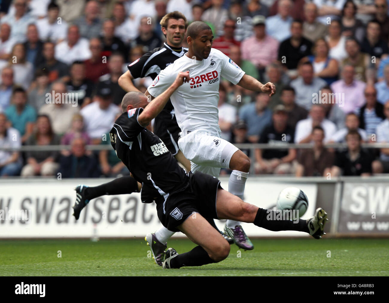Ipswich's Damien Delaney clears under pressure from Swansea's Luke ...