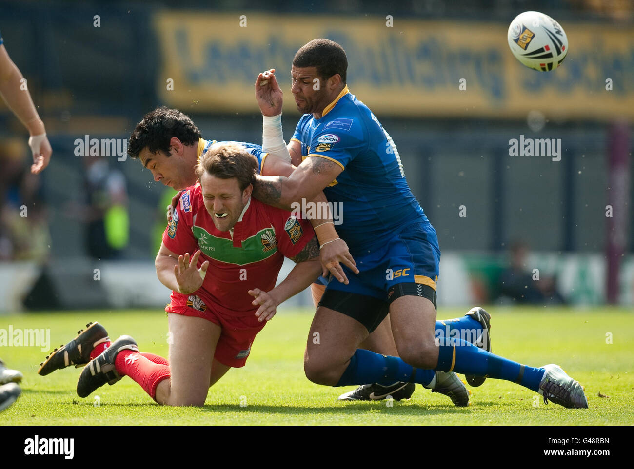 Crusaders' Peter Lupton is tackled by Leeds' Kylie Leuluai and Ryan ...