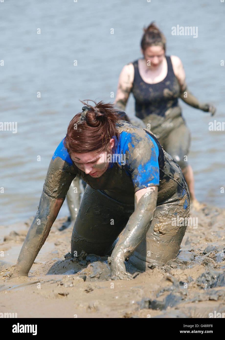 A competitor struggles in the mud during the annual Maldon Mud Race on ...