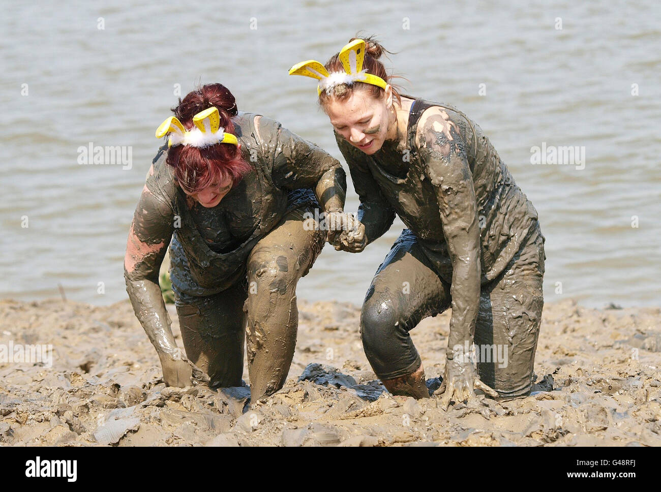 Competitors struggle in the mud during the annual Maldon Mud Race on ...