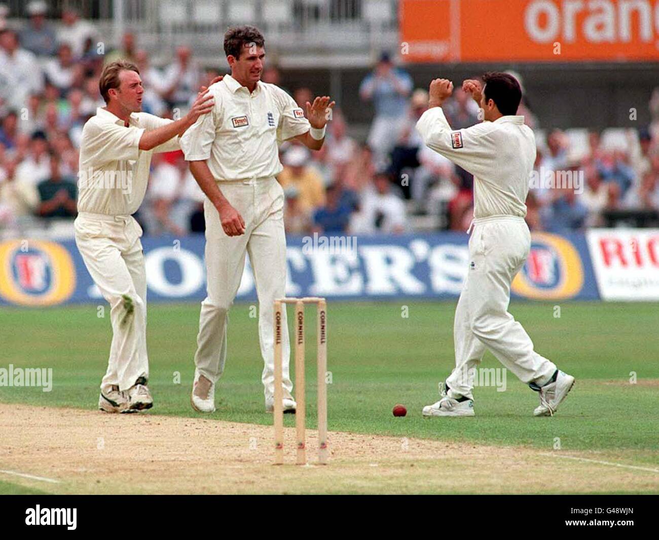 Andy Caddick (centre) celebrates with England team mates Phil Tufnell ...