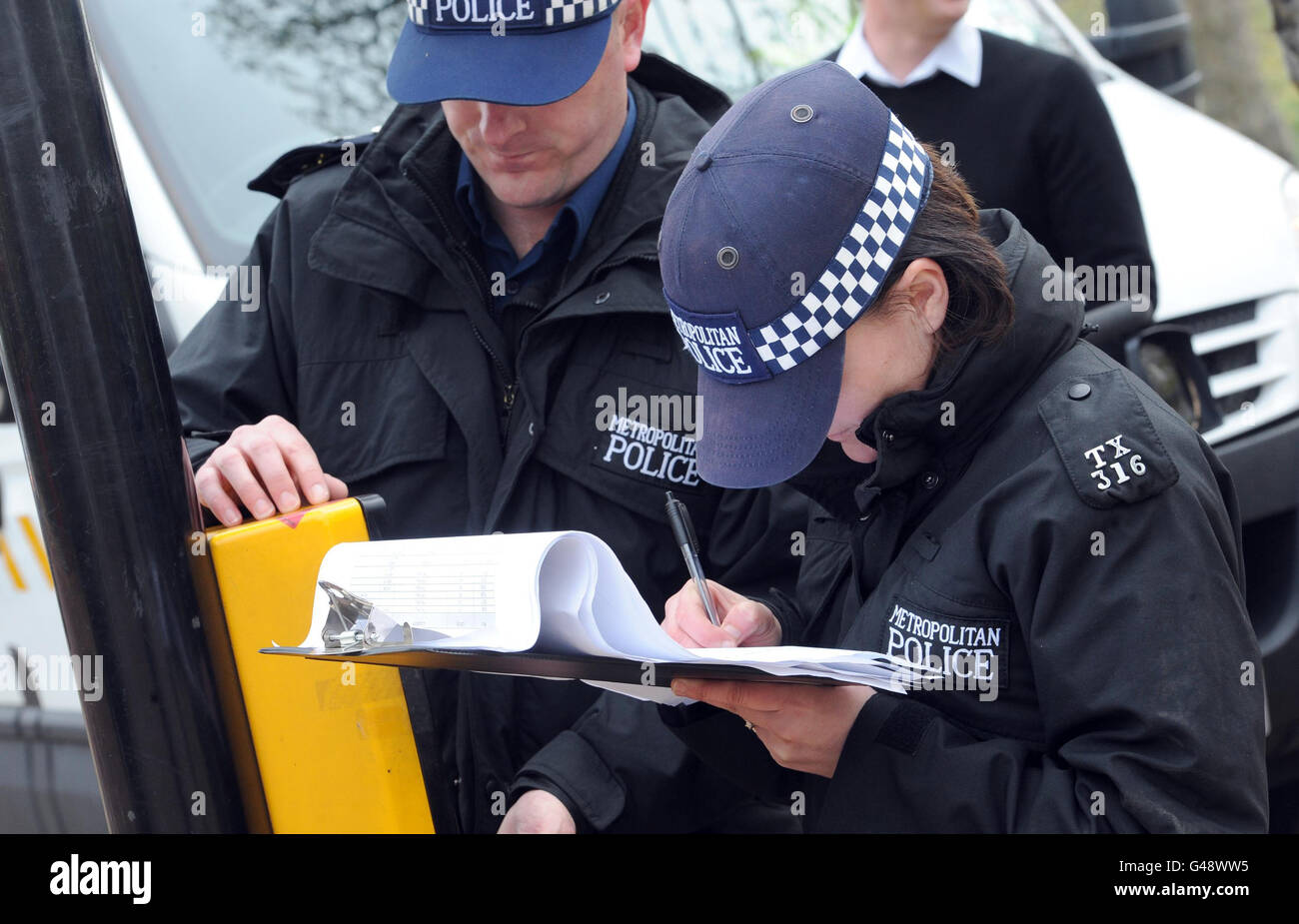 Metropolitan police officers carry out security checks on drains and ...