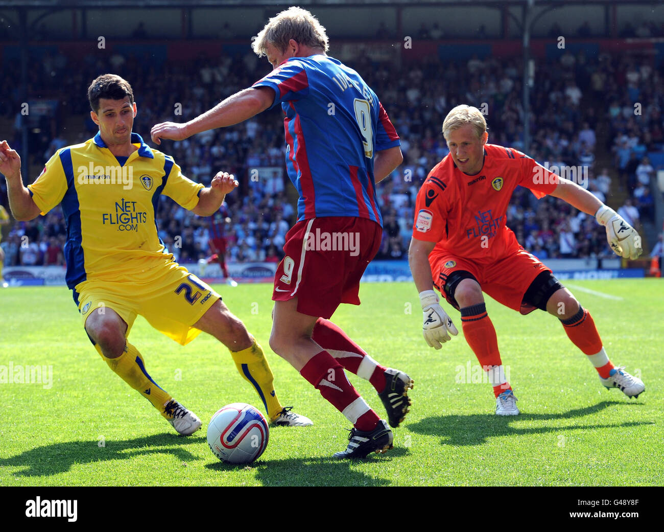 Leeds' goal keeper Kasper Schmeichel races out of his area to challenge ...