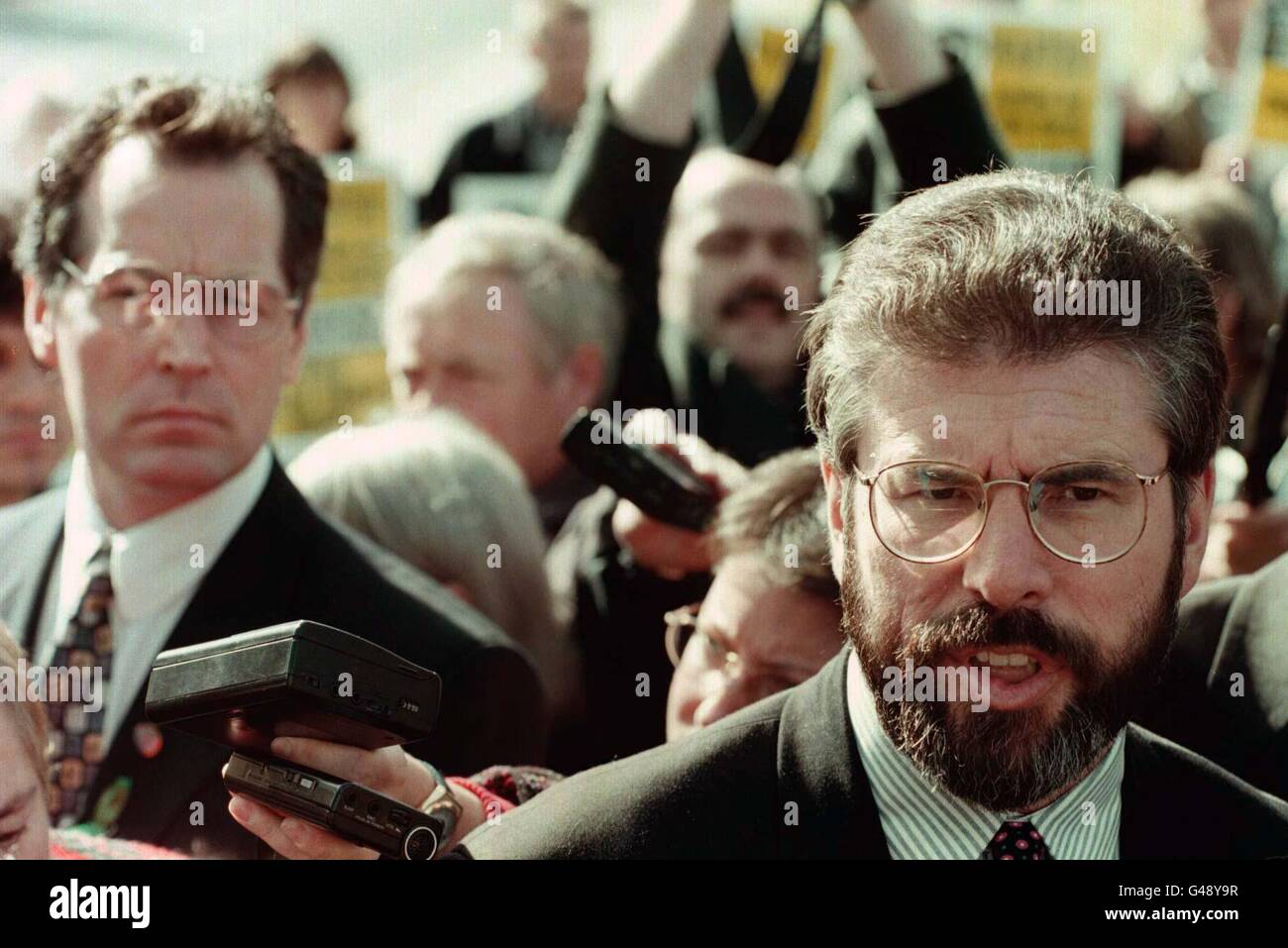 Sinn Fein President, Gerry Adams and Gerry Kelly (left) surrounded by ...
