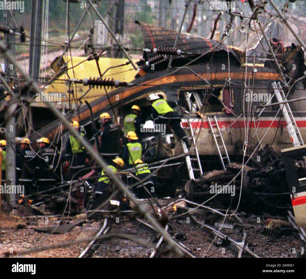 Rescue workers search part of the wreckage of a high speed passenger ...