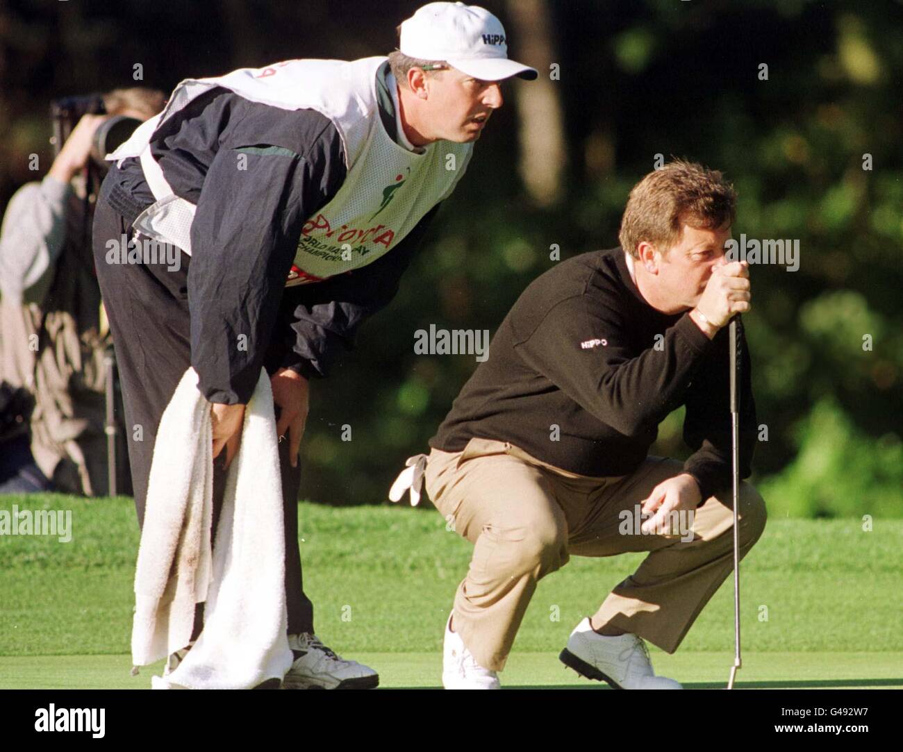Ian Woosnam of Wales , along and his caddie contemplate his putt in his ...