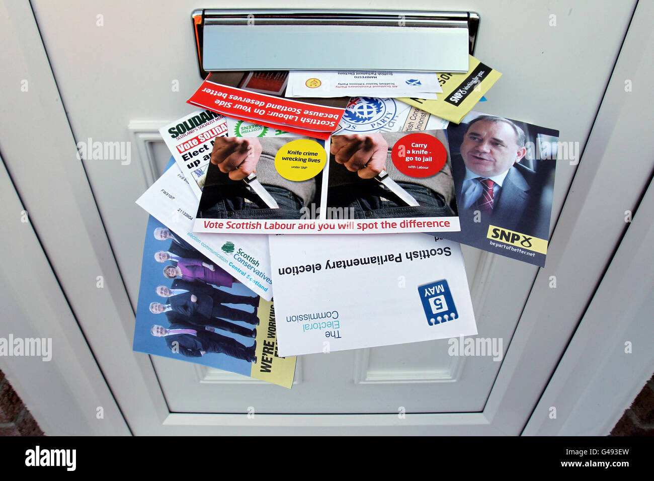 Campaign leaflets sit in a letter box after being delivered to a house ...
