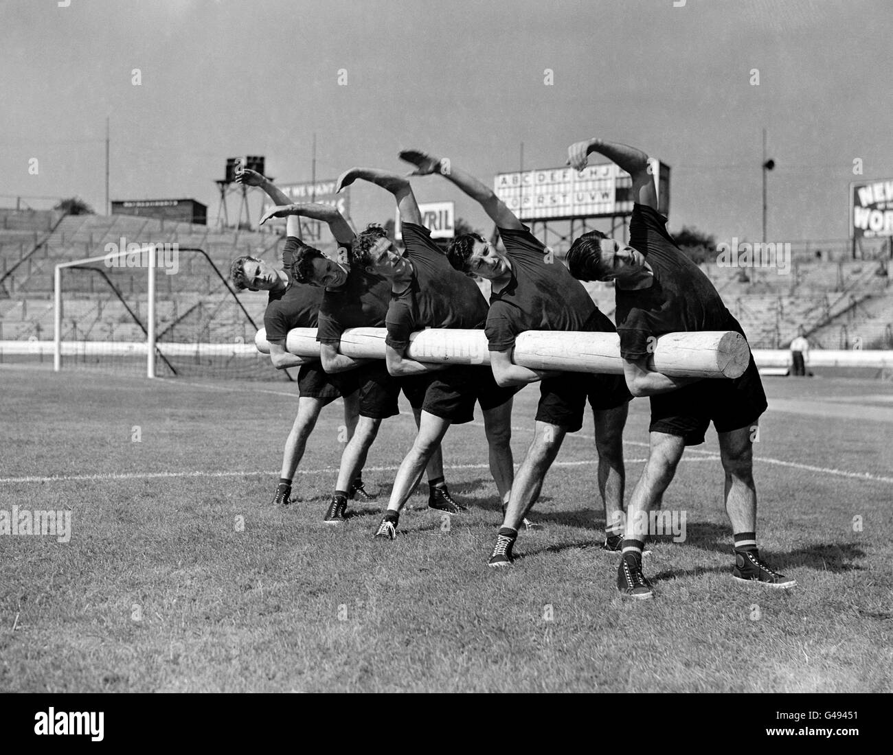 Members chelsea team stretch holding 125lbs tree log training hi-res ...
