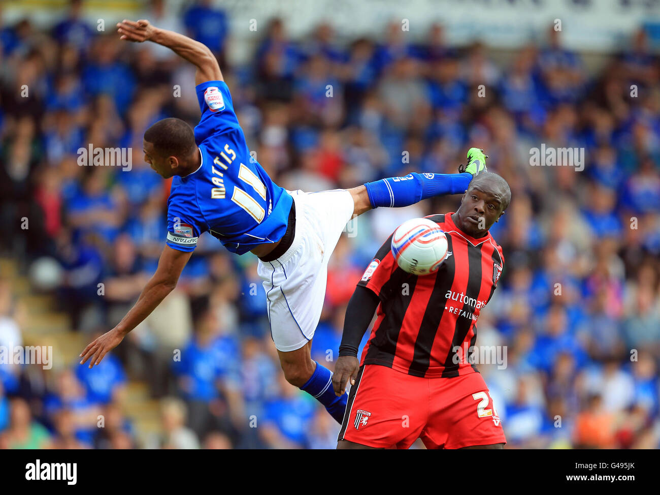 Chesterfield's Dwayne Mattis (left) and Gillingham's Adebayo Akinfenwa ...