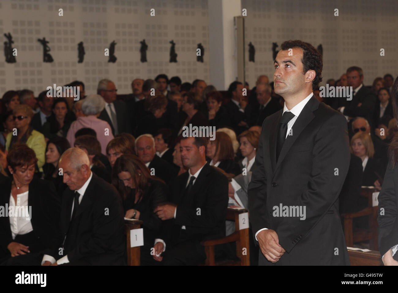 Ivan Ballesteros follows the funeral service inside the parish church ...