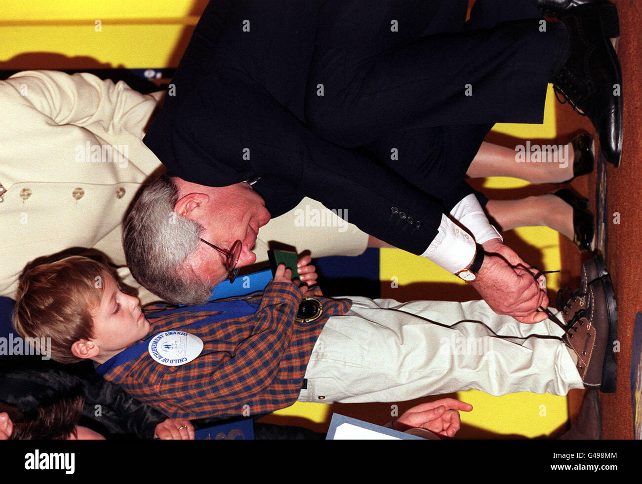 Four-year-old Scott Starkey has his laces tied by former Prime Minister ...