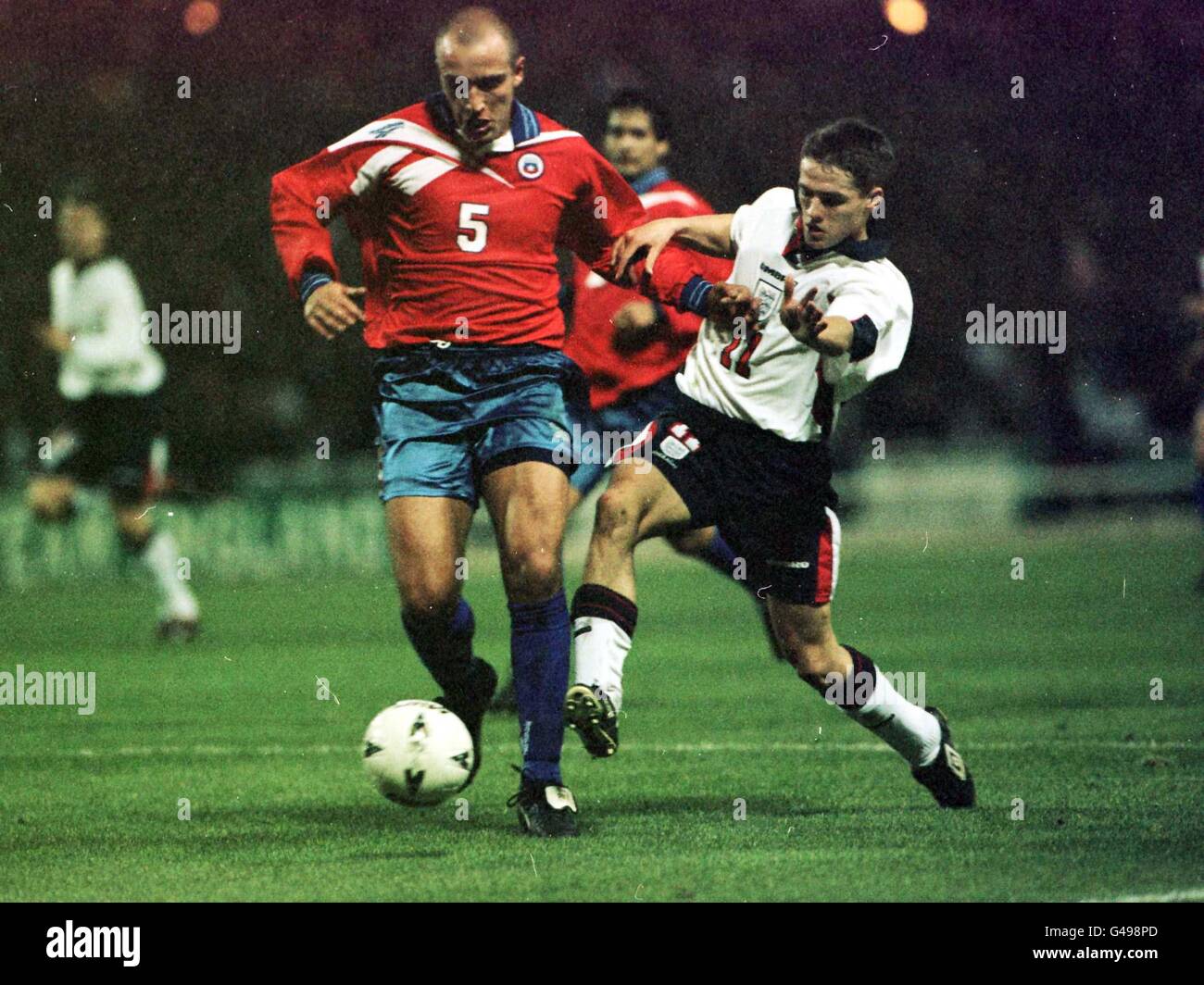 England's Michael Owen (right) and Chile's Javier Margas in action ...