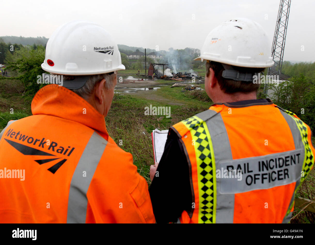 Network Rail workers at the scene of a fire at a railway shed next to ...