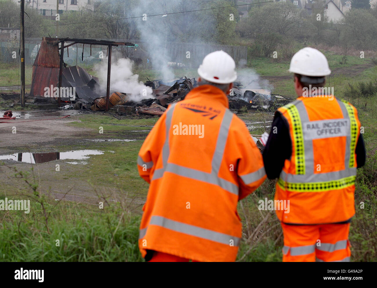 Network Rail workers at the scene of a fire at a railway shed next to ...