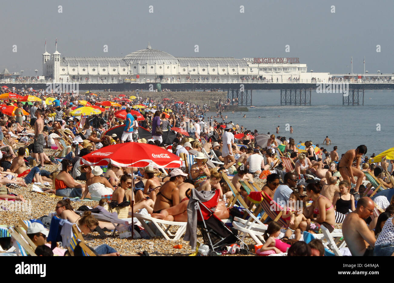 A general view of people enjoying the sun on the beach in Brighton ...