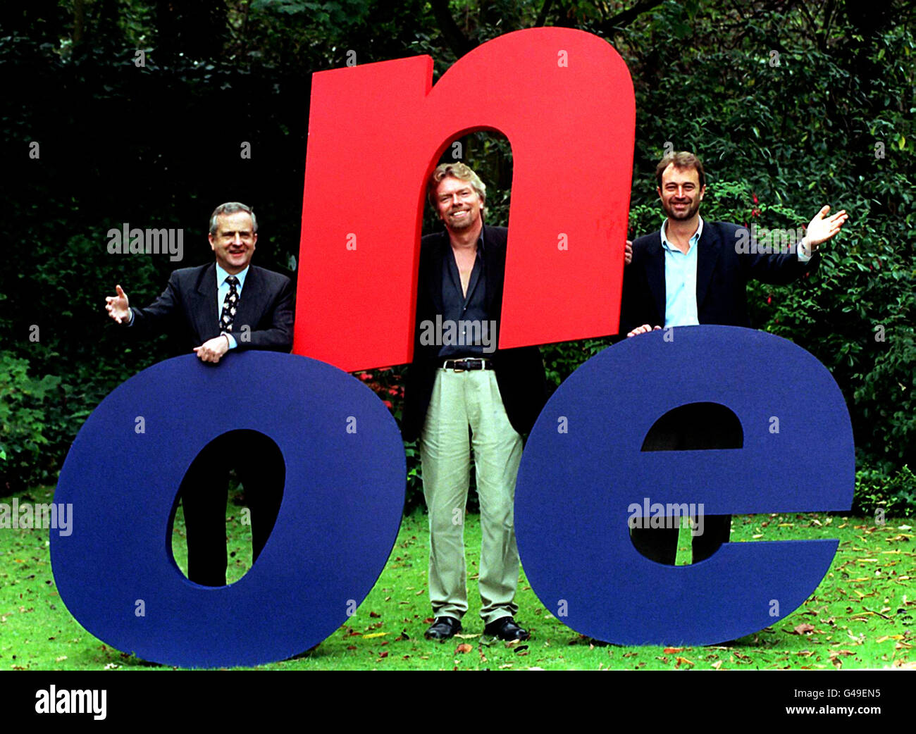 Entreprenuer Richard Branson (centre) stands between two of his latest ...