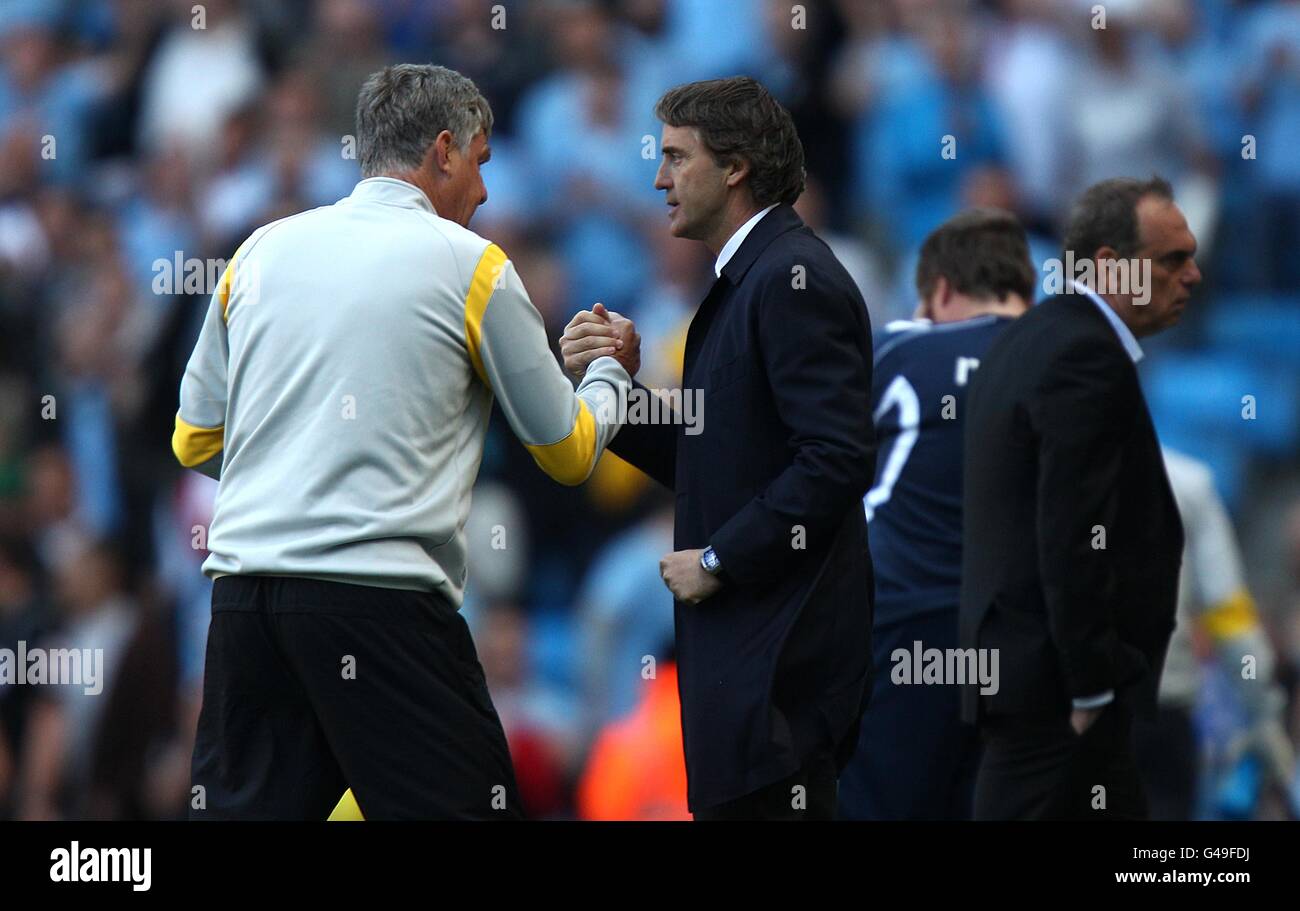 Manchester City manager Roberto Mancini (right) celebrates victory with ...
