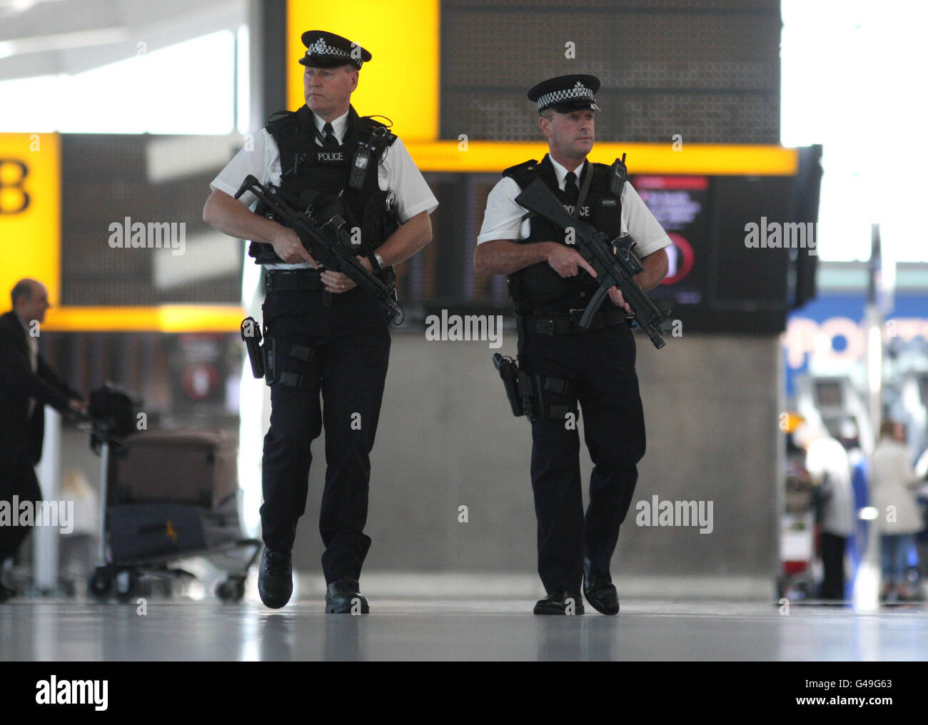 Police officers during routine patrol in terminal of heathrow airport ...
