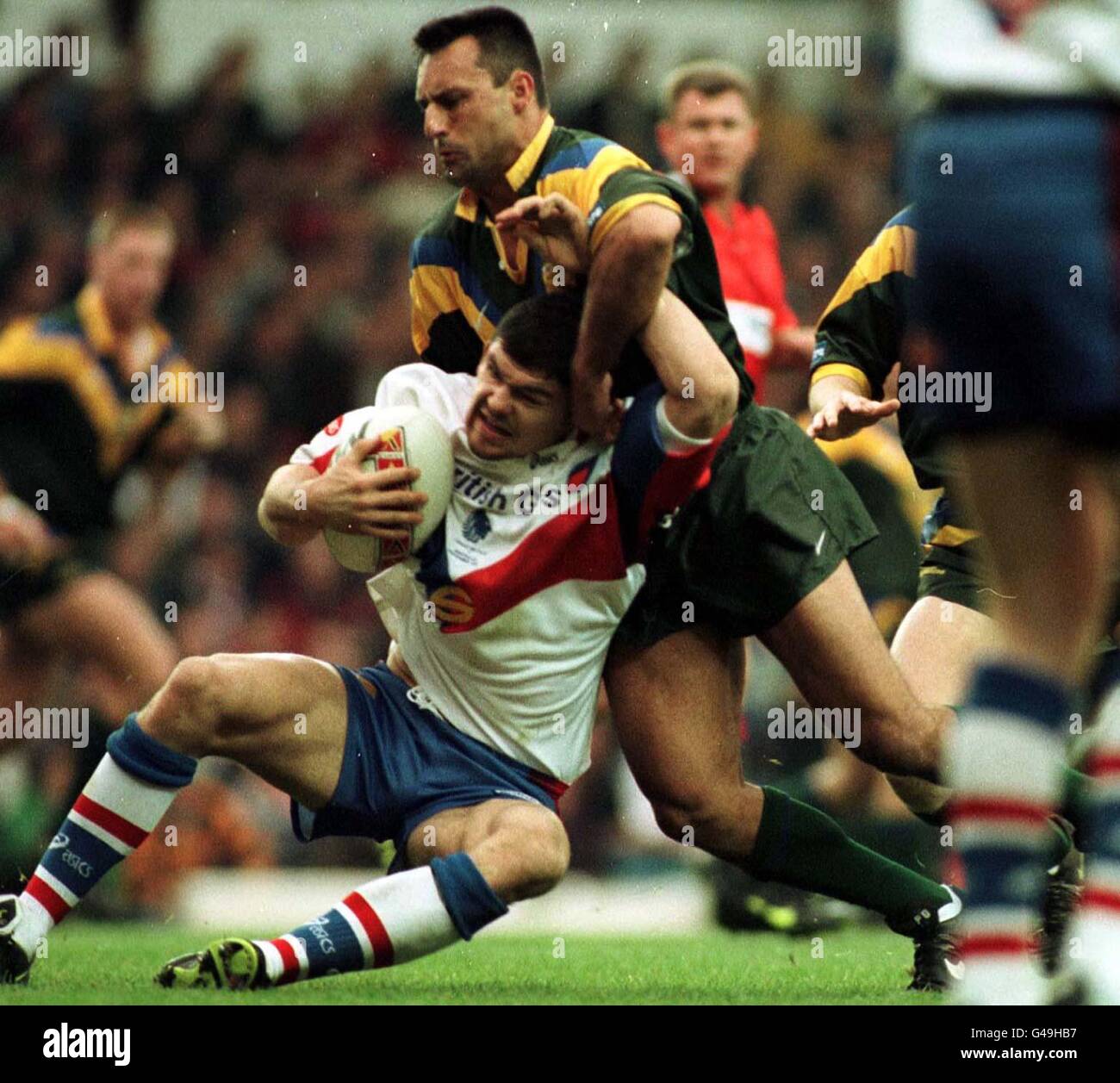 England captain Andrew Farrell is pinned down as Australia charge ...