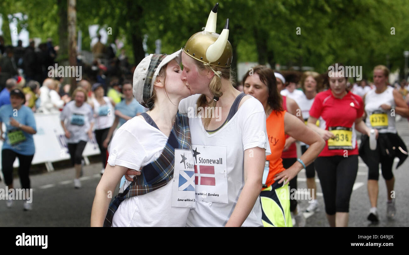 Runners celebrate as they cross the finish line during the Ignis Asset ...