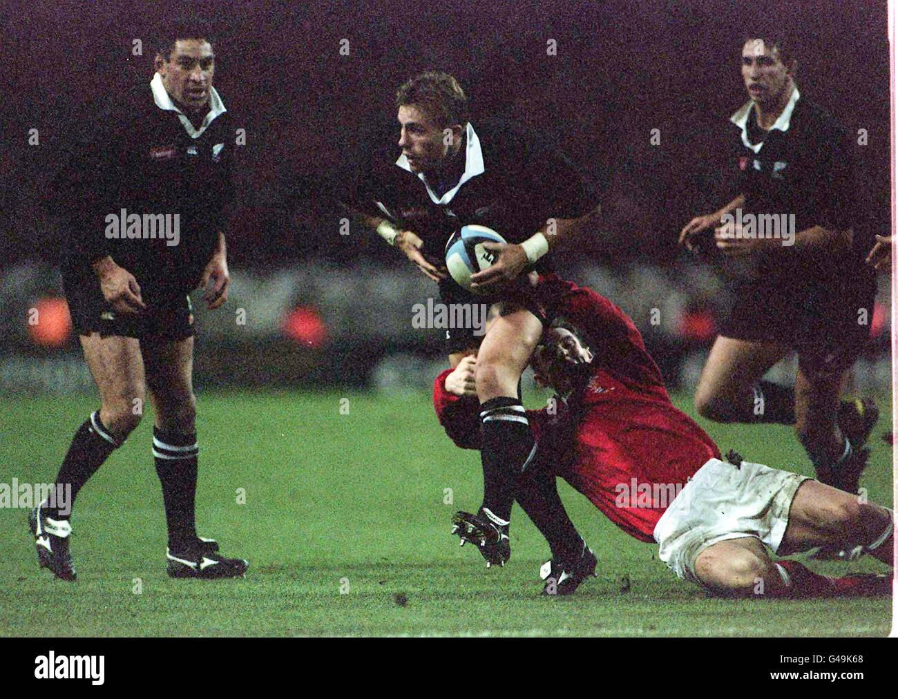 All blacks justin marshal is tackled by rob howley hi-res stock ...