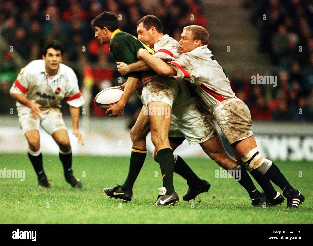 England's Will Greenwood (2nd right) and Neil Back attempt to stop the ...