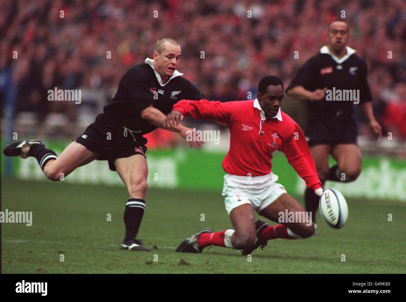 Wales's Nigel Walker and New Zealand's Christian Cullen in action ...
